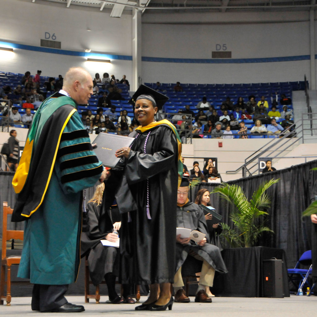 dr-lennox-handing-out-a-diploma - Spirit Magazine