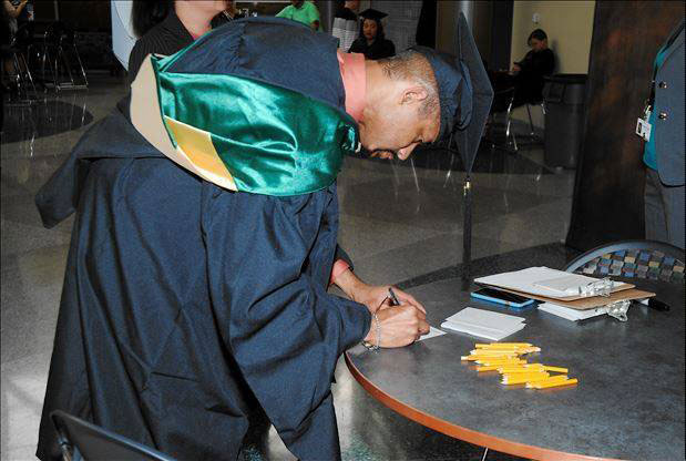 grad-signing-in - Spirit Magazine